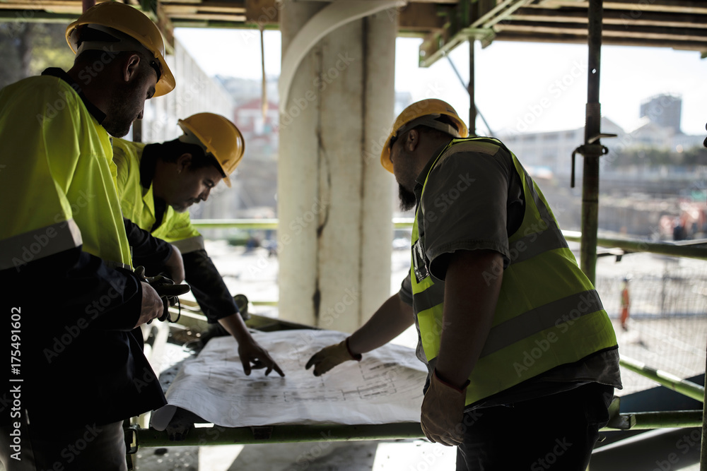 Construction workers looking at plans Stock Photo | Adobe Stock
