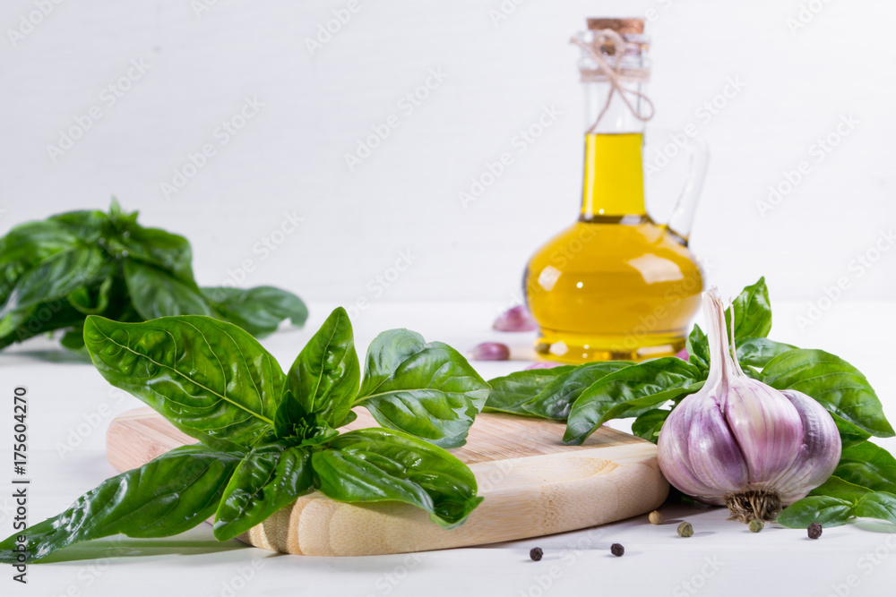 Fresh green basil with garlic and olive oil on white background Stock ...