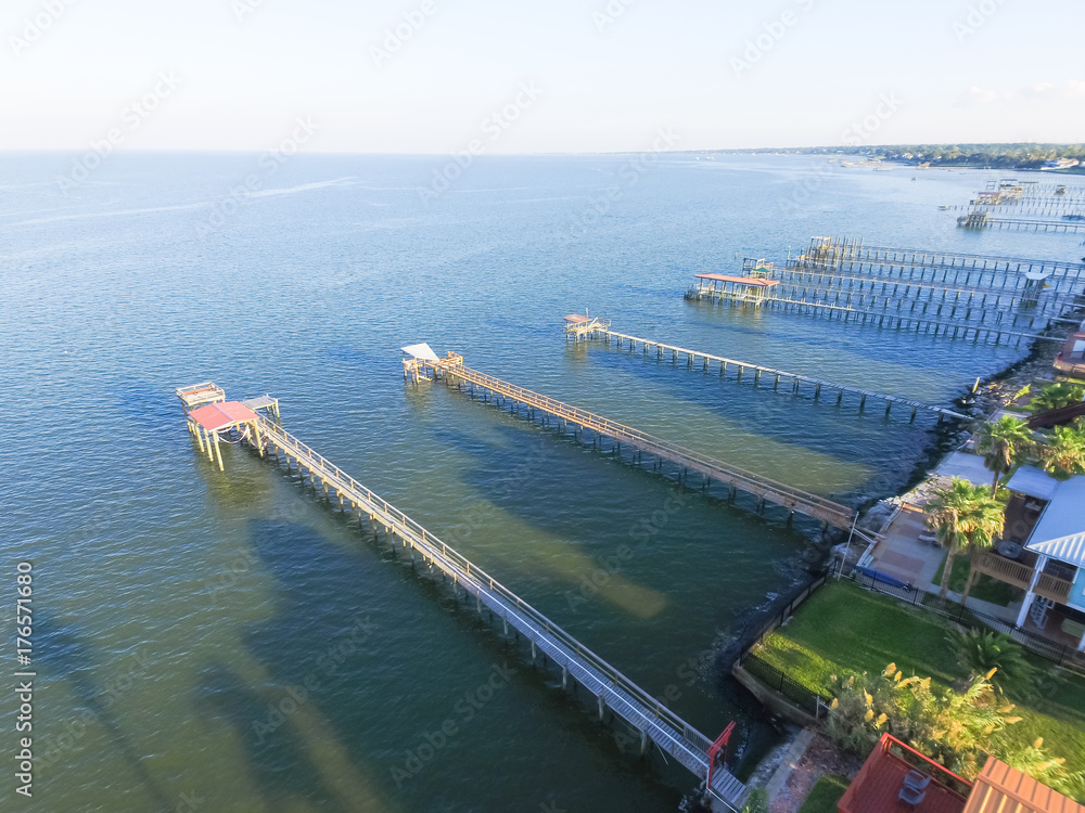 Aerial view three-story waterfront vacation home with fishing piers ...