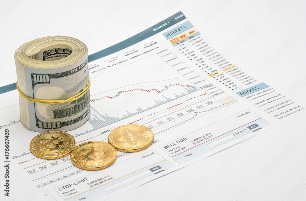 crypto currency of bitcoins and a bundle of hundred dollar bills lies ...