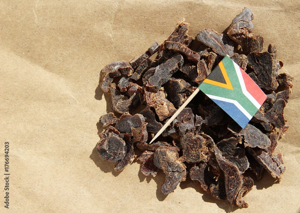 Biltong (protein snack) on brown paper, this is a traditional food ...