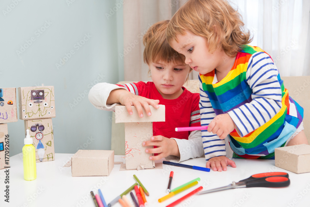 two little children together in creativity of the house. Happy kid ...