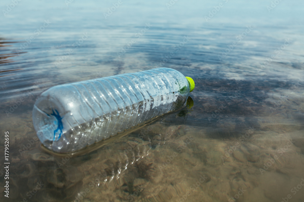 Plastic Bottle Floating in the Shallow Water Stock Photo | Adobe Stock