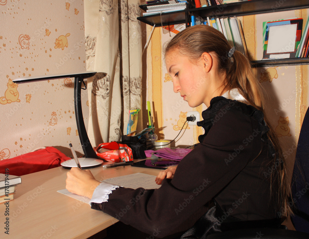 school girl writing something in an exercise book, doing homework Stock ...