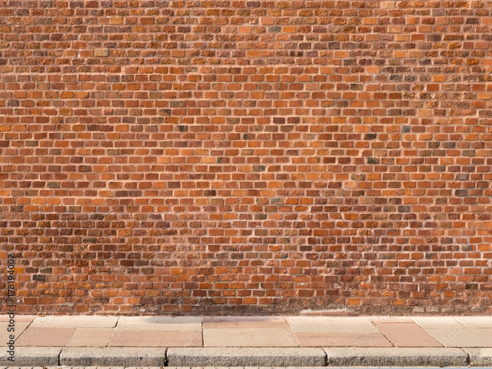 Red brick wall with sidewalk Stock Photo | Adobe Stock