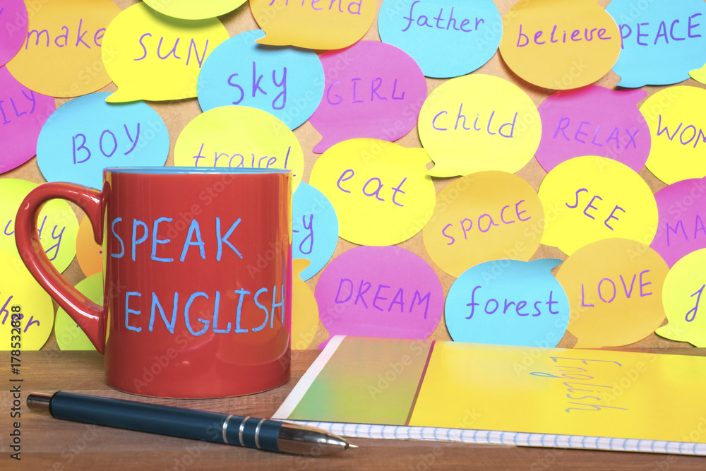 Study English concept, a mug with written words Speak English, notebook ...