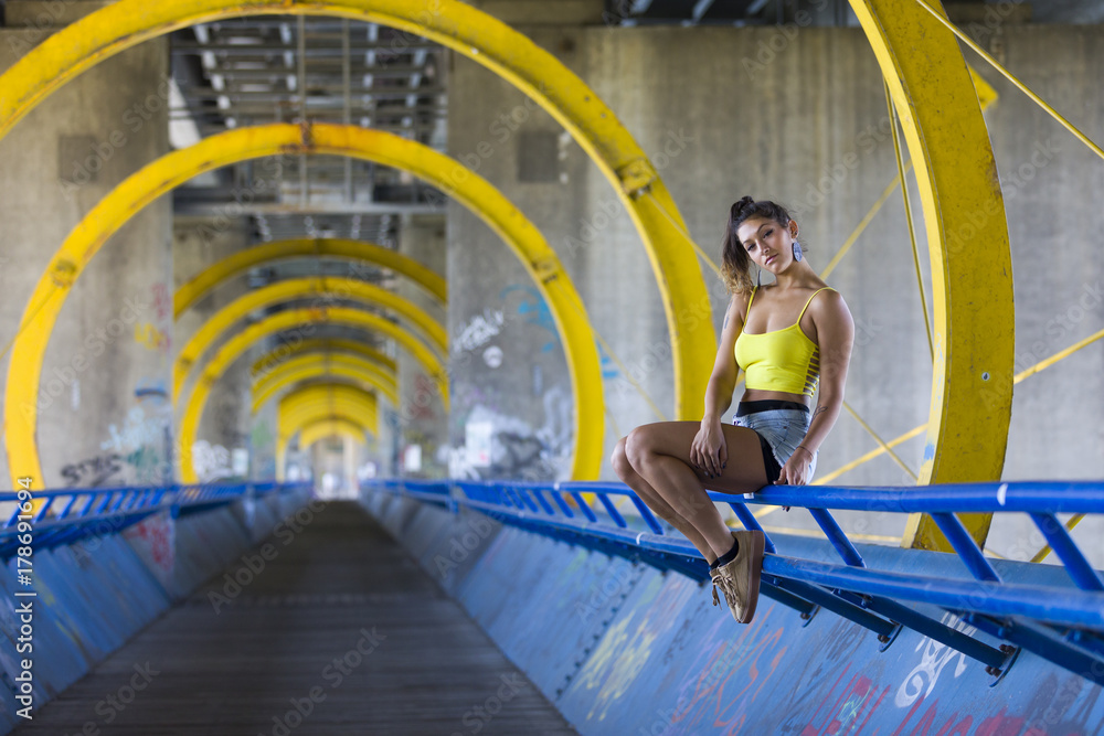 Attractive woman wearing yellow belly top Stock Photo | Adobe Stock