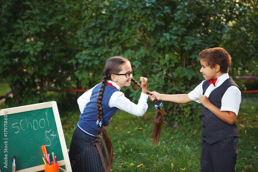 boy pulling girl's hair, flirting Stock Photo | Adobe Stock