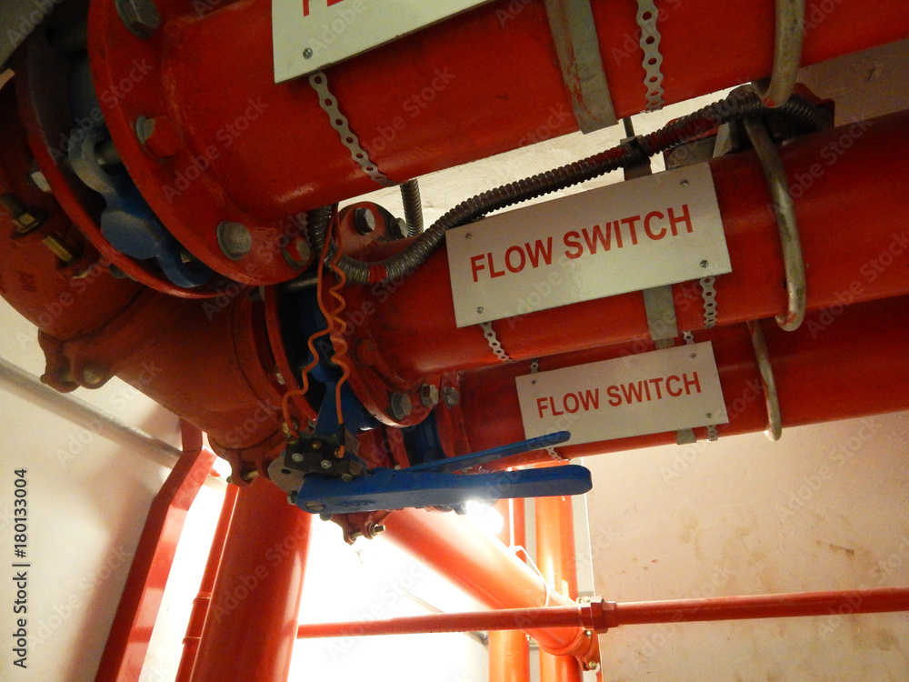Sprinkler system pipe in hang at the slab soffit. Sprinkler is an ...