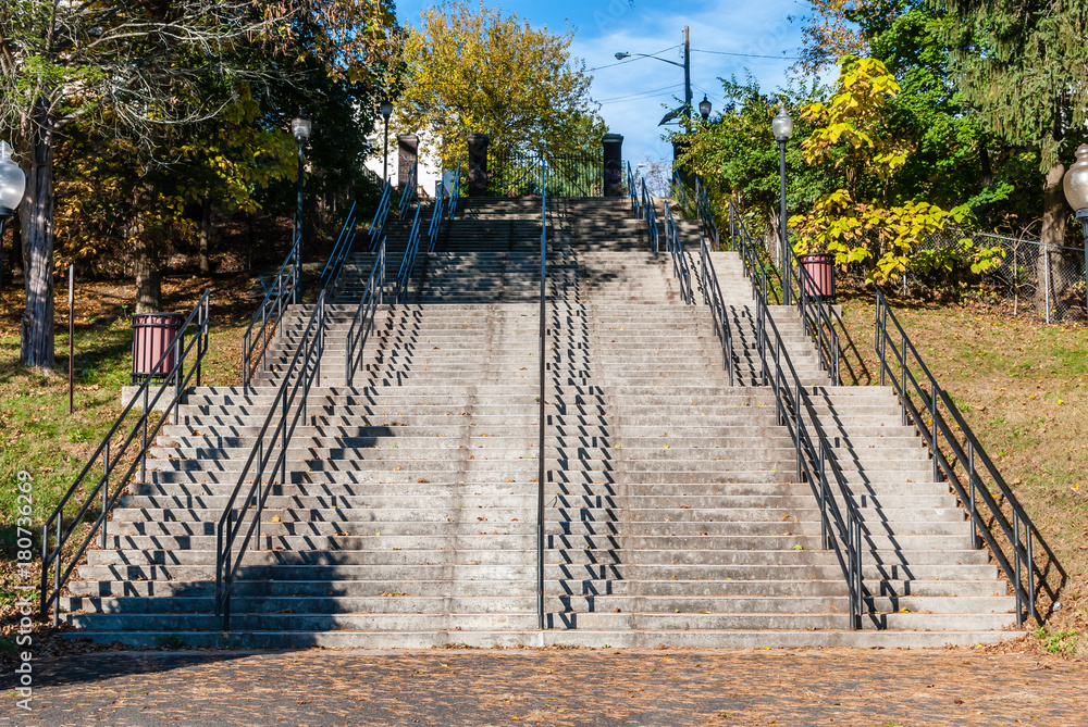 Outdoor concrete park steps. Parks and recreation design with tree and shrub background. Nature ...