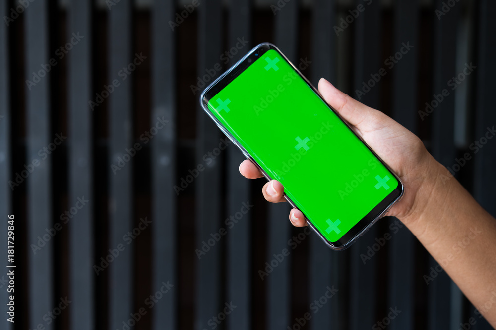 holding a smartphone in the hands of a green screen green screen, hand ...