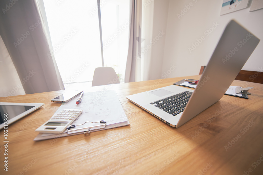 Wide angle perspective view of office workplace with laptop and smart ...