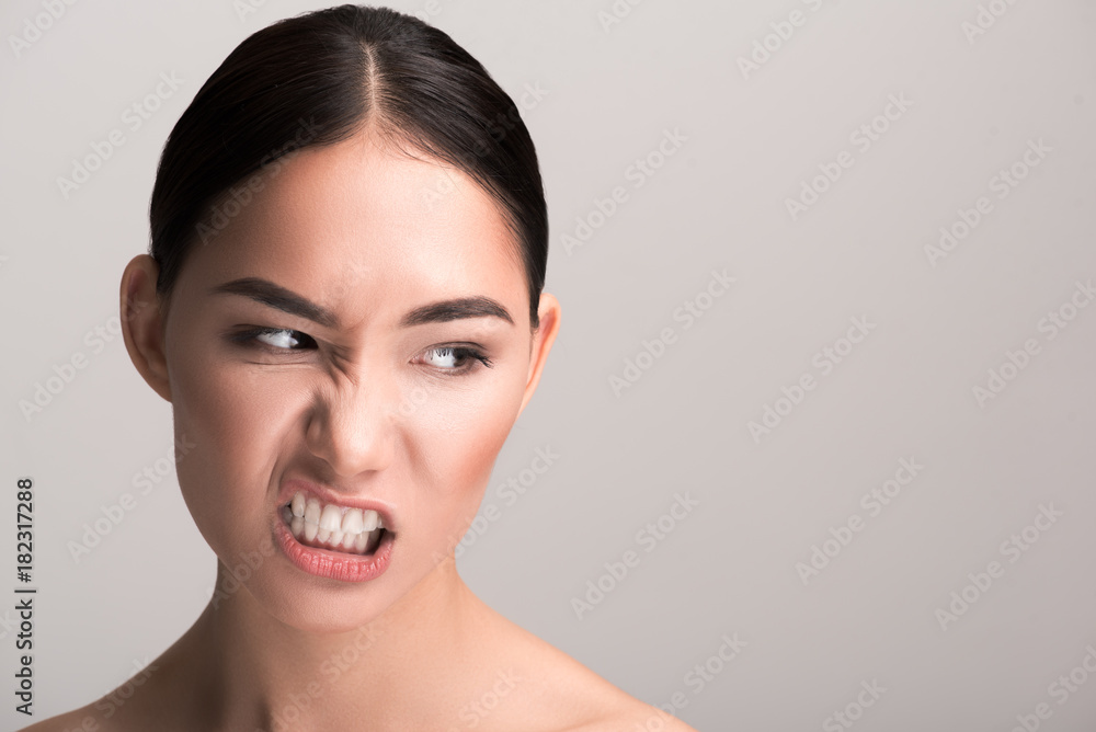 Close-up portrait of asian girl is standing and looking aside with ...