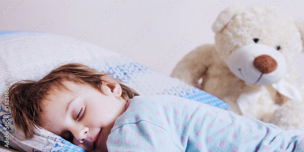 Bedtime. Happy and funny dreams of a little girl. Child girl relaxing ...