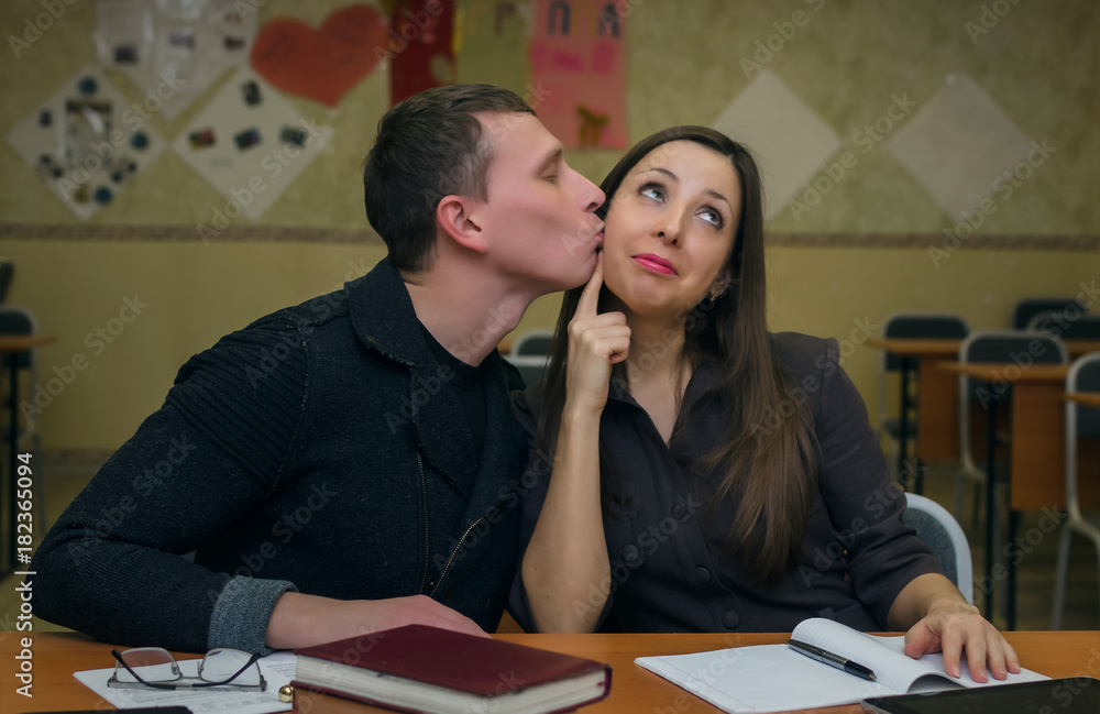 Young man student confesses love to his girlfriend classmate and kisses ...