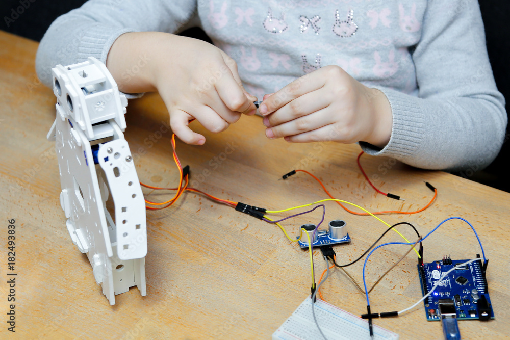 Girl programming and creating a robot at a stem class robotics Stock ...