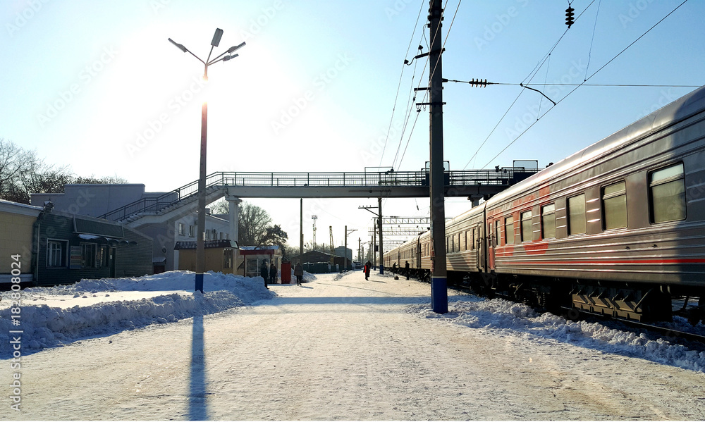 Passenger Train and Freight Train alight at a train station along the ...