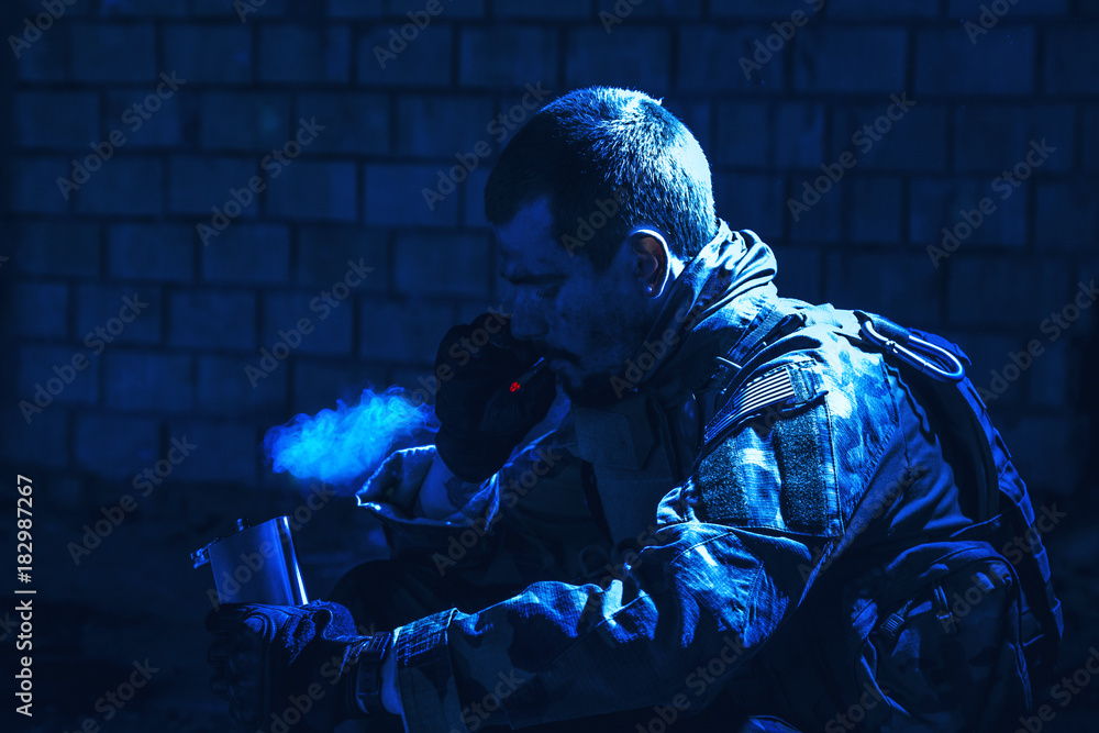 Special forces soldier after the fight sitting in ruined building ...