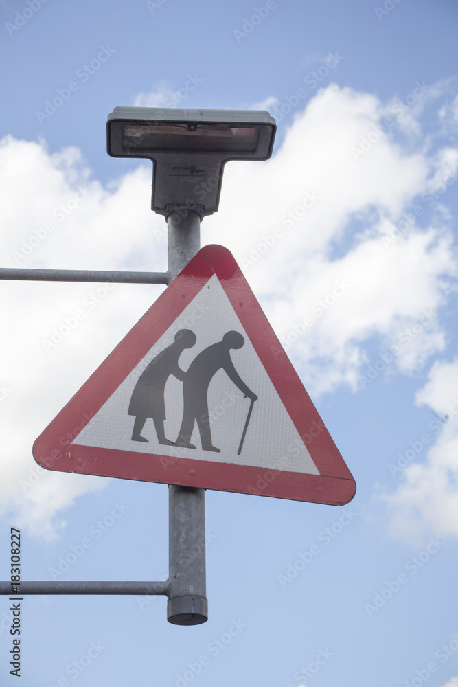Sign elderly people crossing on the street. Stock Photo | Adobe Stock