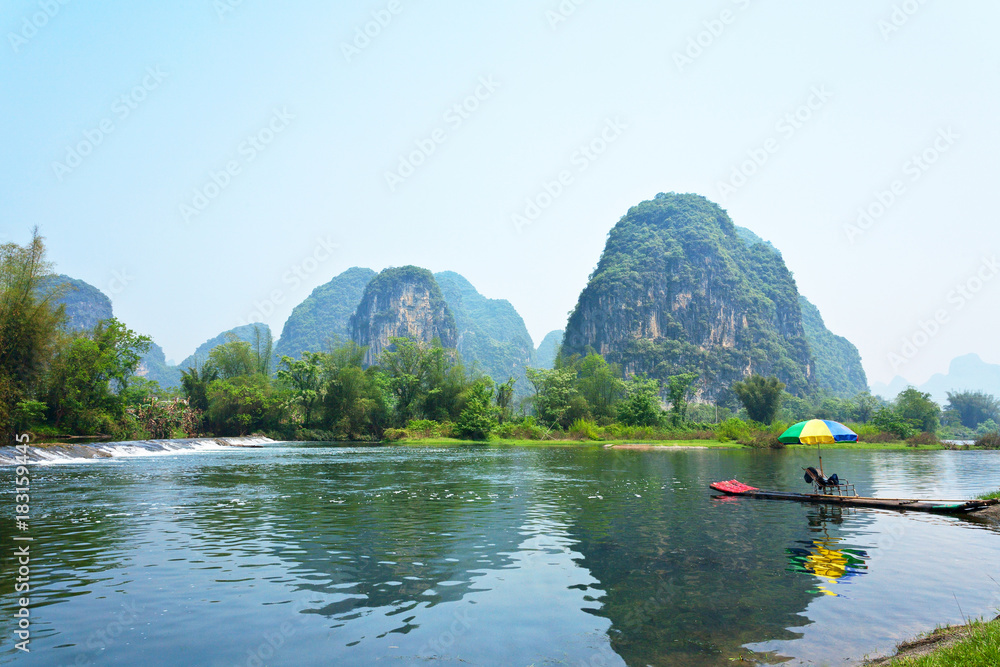 China. Yangshou. Li River. Exotic landscape with karst hills reflecting ...