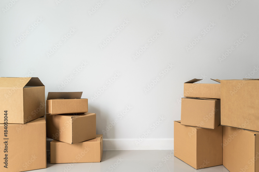 Stack of cardboard boxes in empty room Stock Photo | Adobe Stock