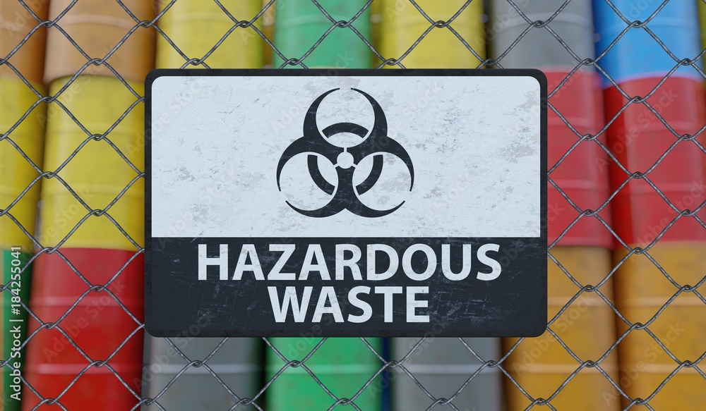 Hazardous waste sign on chain link fence. Oil barrels in background. 3D ...