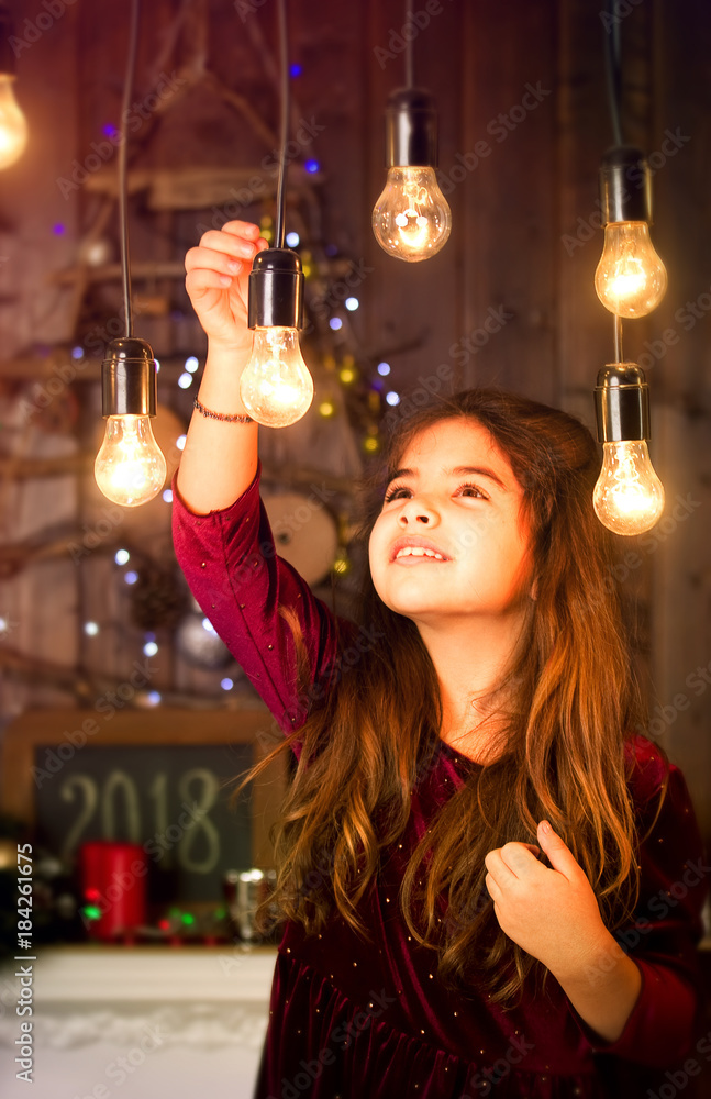 little girl is played with old lamps decorating a room against the ...
