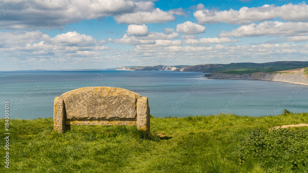 Stone bench at the South West Coast Path with a view over the Jurassic ...