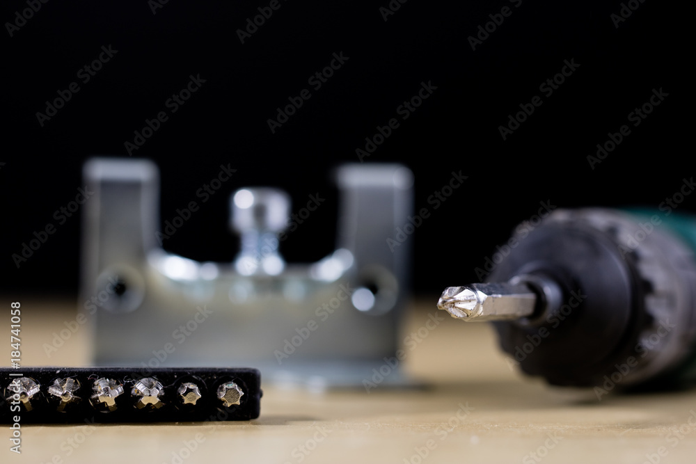 Carpentry tools and accessories on a workshop table. Hinges and screws ...