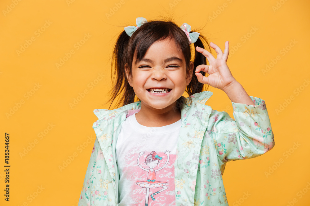 Happy little girl child showing okay gesture. Stock Photo | Adobe Stock