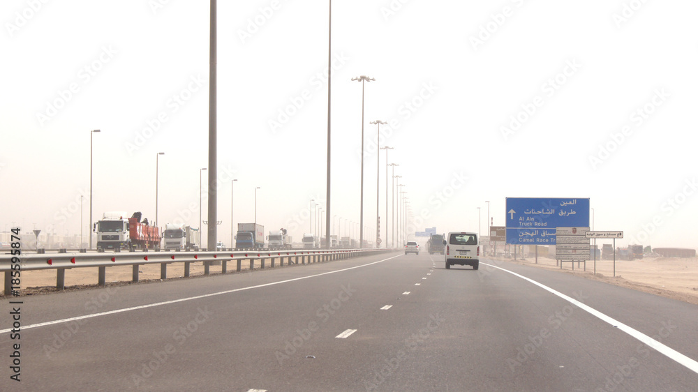 ABU DHABI, UNITED ARAB EMIRATES - APRIL 3rd, 2014: Trucks driving on a ...