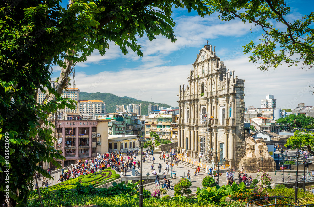 Ruins of Saint Paul's Catholic Church with tourists. They are one of ...