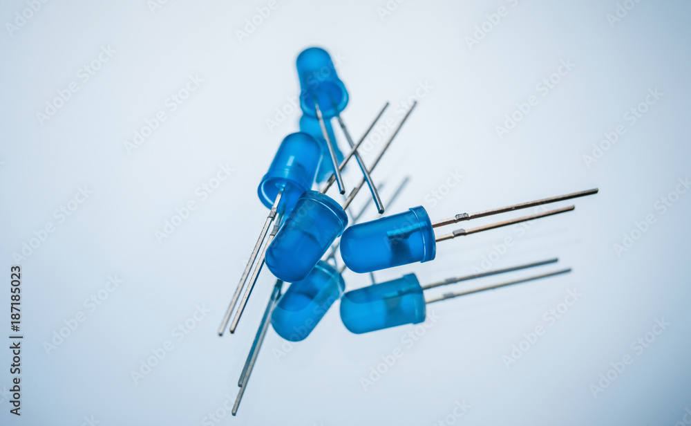blue light emitting diode on white background. active electronic ...