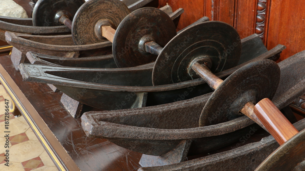 Antique herb roller mill grinding tool. Iron grinding wheel with wooden ...