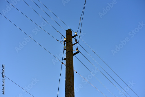 Utility Pole against Blue Sky supporting overhead power lines ...