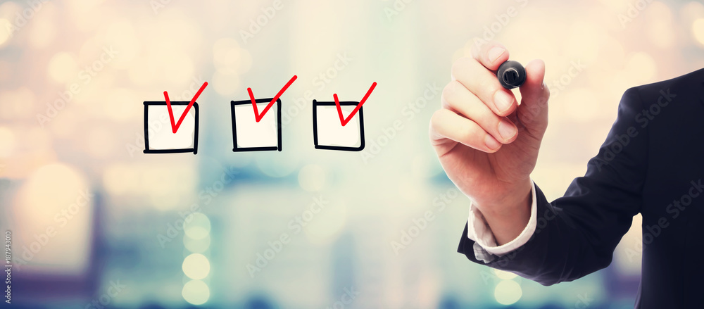 Checklist with businessman on blurred abstract background Stock Photo ...