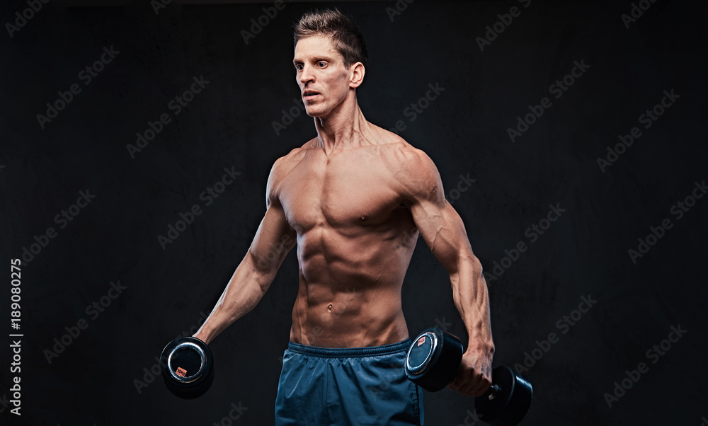 Shirtless athletic male doing shoulders exercises. Stock Photo | Adobe ...