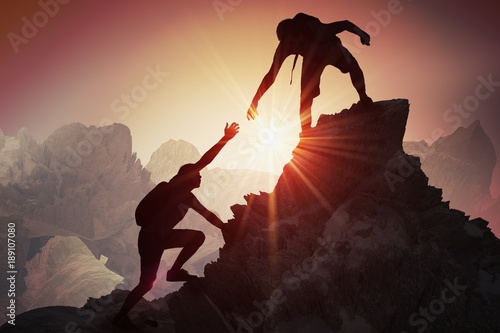 Help and assistance concept. Silhouettes of two people climbing on ...