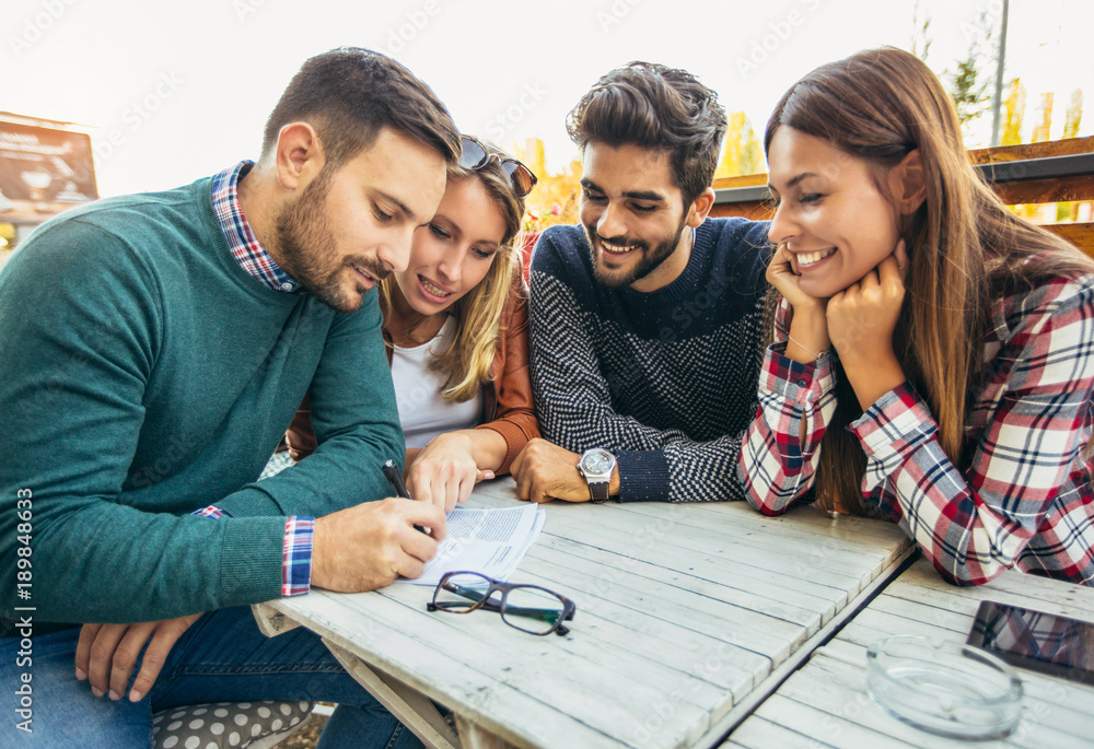 Group of four friends having fun a coffee together. Two women and two ...