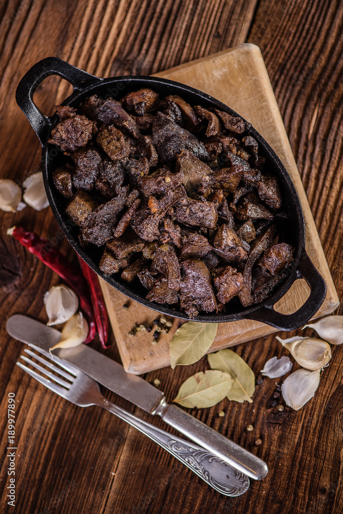 braised beef and lamb meat, liver, lungs and heart dish in black iron ...