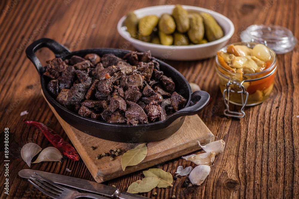 braised beef and lamb meat, liver, lungs and heart dish in black iron ...