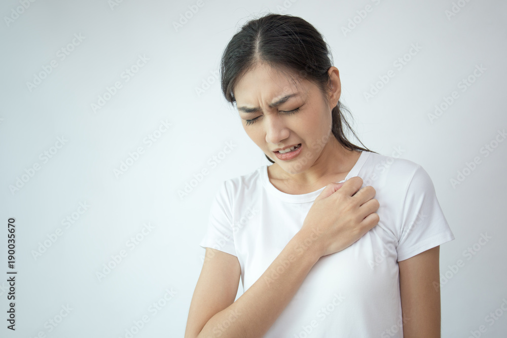 Woman touching her breast with hands. Young asian woman feel pain in her heart. isolated on ...