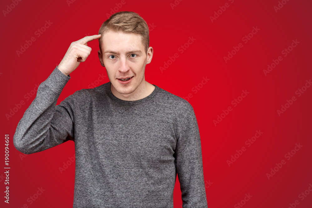 Portrait of dissatisfied young men, knocking himself on the head with a ...