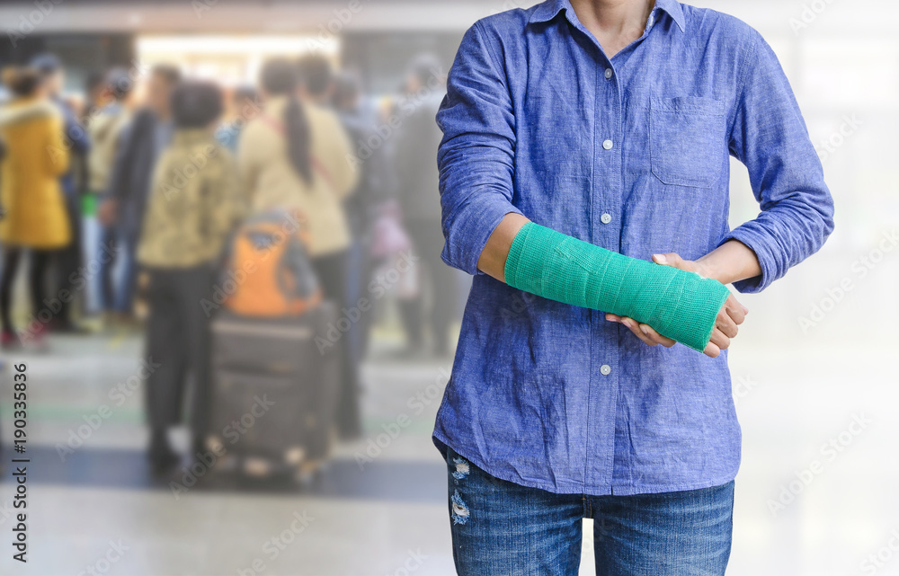 Injured woman with green cast on hand and arm on motion blur in the ...