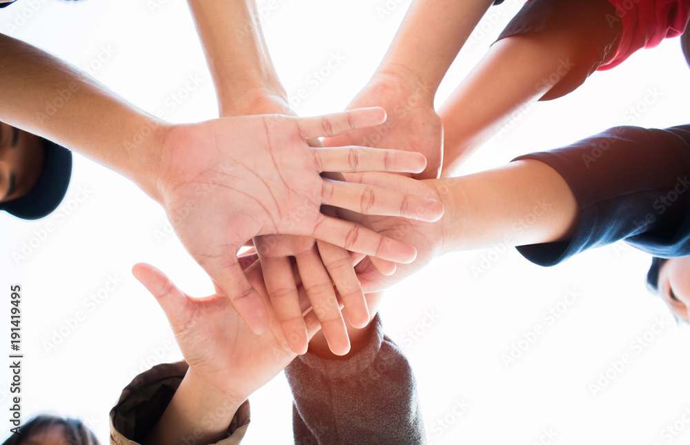 Unity and teamwork Concept: Group of friends hands together. Top view ...