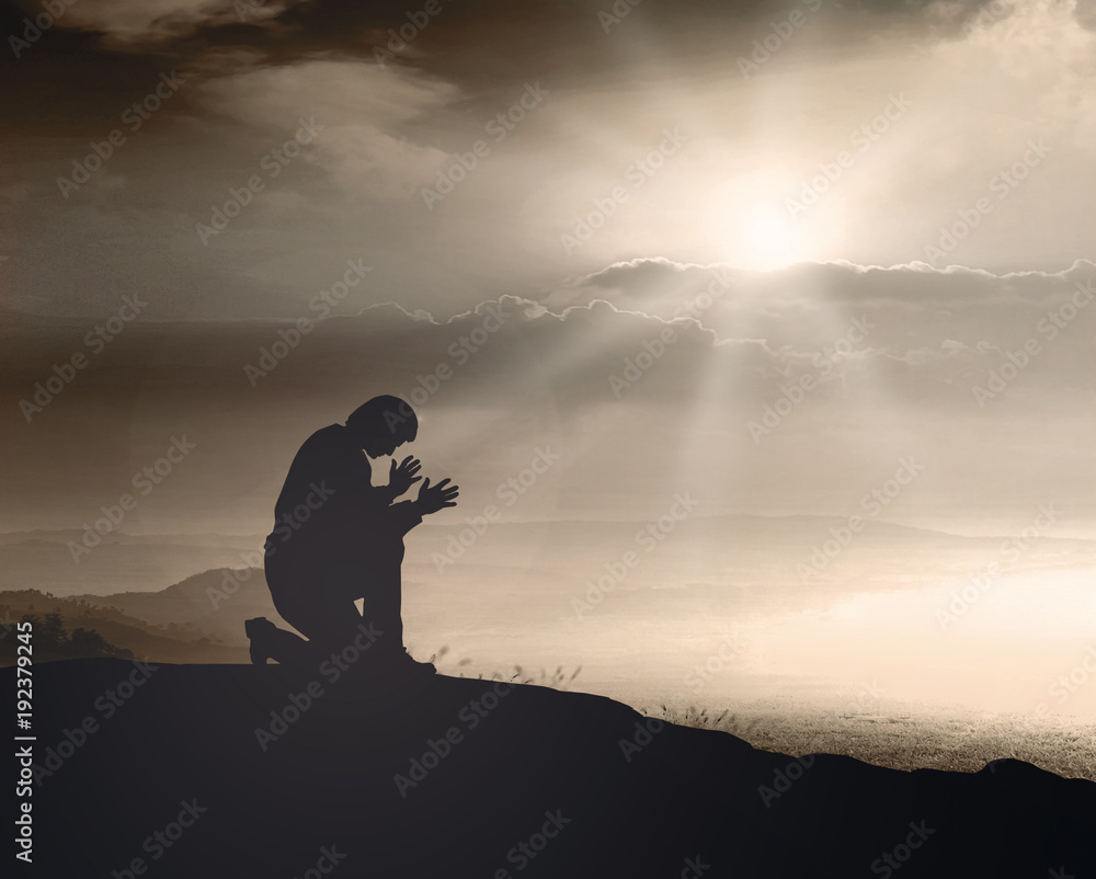 Prayer kneeling and praying to God on mountain autumn sunset background ...