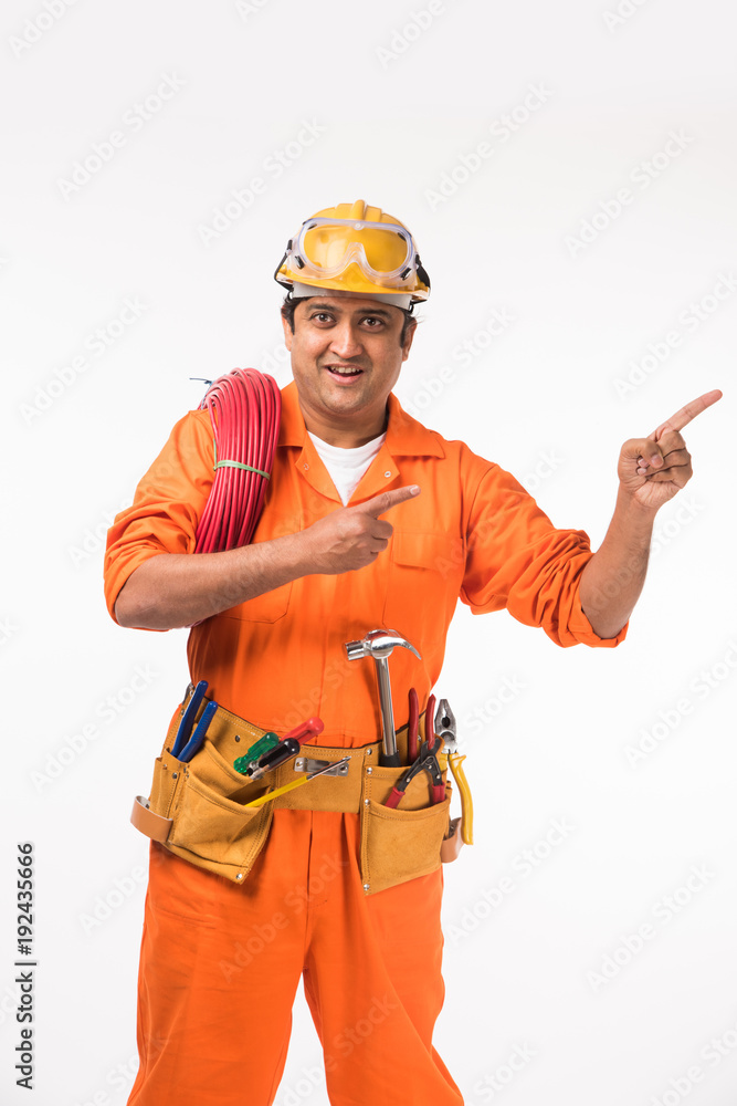 Indian electrician engineer in action with wire cutter, drilling ...