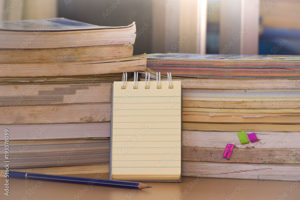 Notepad with pencil on wood board background.using wallpaper for ...
