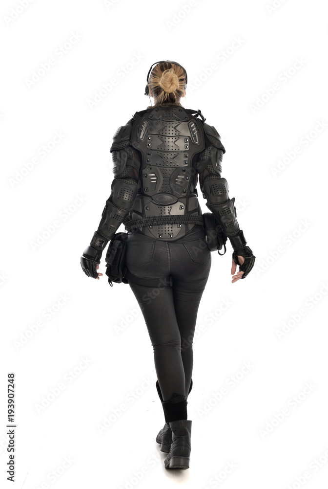 full length portrait of female soldier wearing black tactical armour ...