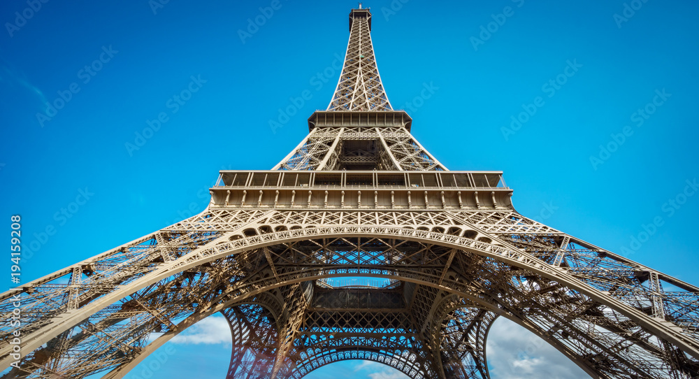 The Eiffel Tower worms eye view over blue sky Stock Photo | Adobe Stock